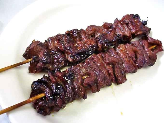 Teriyaki beef sticks&mdash;caramelized, charred perfection on a wooden skewer. The kind of street food that makes you wonder why you ever ate anything else.