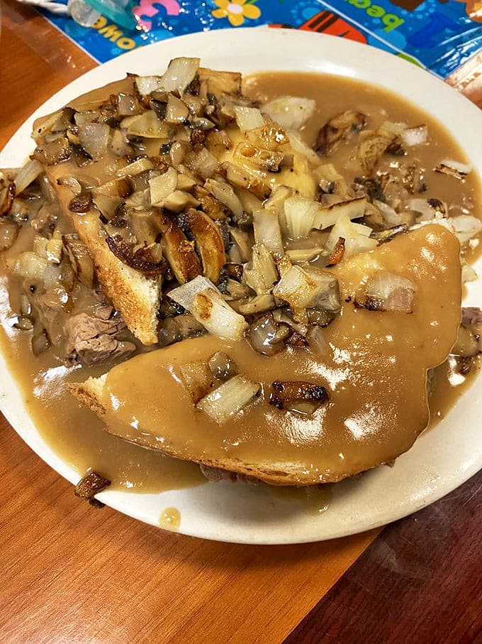 Hot beef drowning in gravy isn't a meal&mdash;it's therapy on a plate, with mushrooms and onions playing supporting roles.