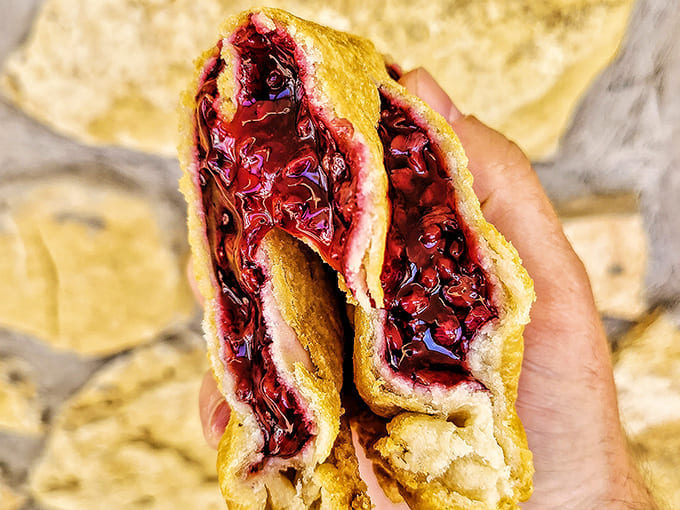 The beautiful mess of a blackberry pie mid-bite. Some of life's greatest pleasures refuse to be contained by mere pastry boundaries.