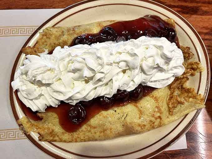 This isn't just a crepe &ndash; it's a blintze vacation package with whipped cream clouds, berry preserves, and enough joy to power you through any Monday.