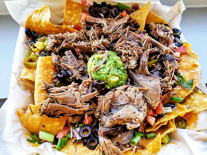 Nachos reimagined as a delivery system for smoky brisket. That dollop of guacamole sitting atop this mountain of deliciousness is like the cherry on a meaty sundae.