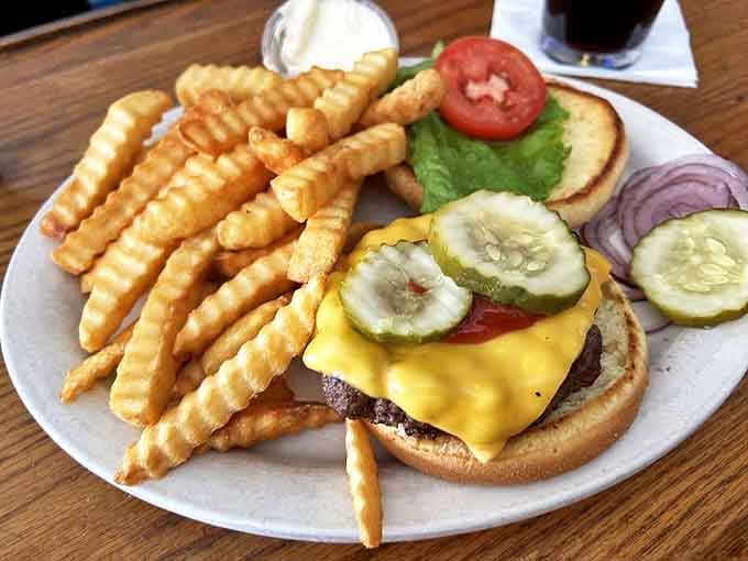 A burger that understands its purpose in life – melty cheese, fresh veggies, and a patty cooked just right. No identity crisis on this plate.