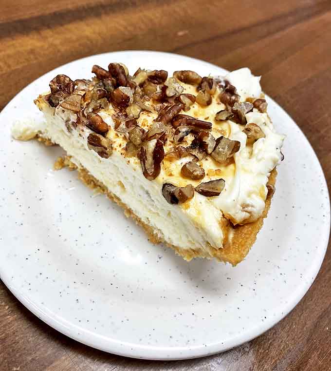 Not all heroes wear capes&mdash;some wear pecans and come on a plate. This cheesecake deserves its own theme music.
