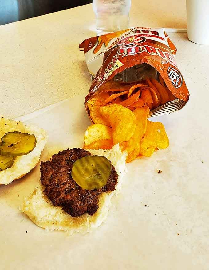 The open-faced burger reveals its simple truth: sometimes pickles and a perfectly seasoned patty are all you need in life.