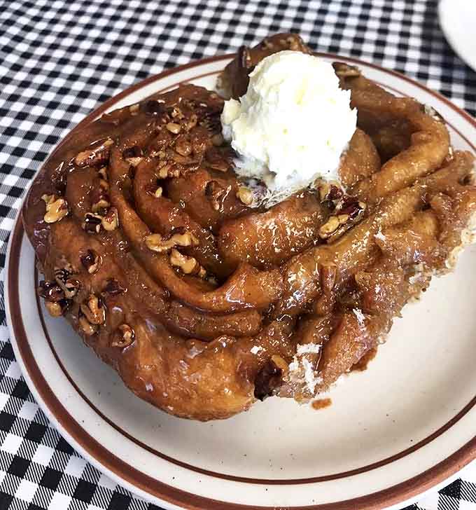 The famous pecan roll in all its glory—a spiral of cinnamon, sugar, and buttery dough that's worth every sticky finger afterward.