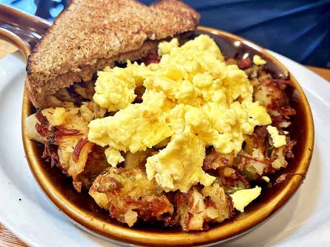 Corned beef hash crowned with perfectly cooked eggs &ndash; a hearty mountain of flavor that puts ordinary breakfast plates to shame.