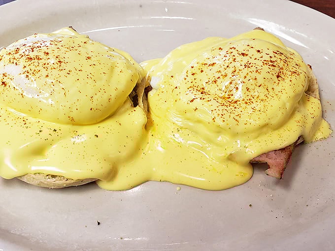 Eggs Benedict with hollandaise so rich it should have its own tax bracket, crowning English muffins that serve as thrones for this breakfast royalty.