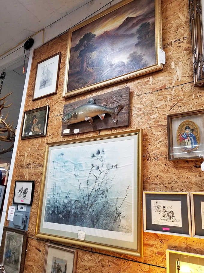 Gallery wall goals from another era. That mounted fish seems to swim between landscapes and portraits, creating an eclectic visual journey through Maine aesthetics.