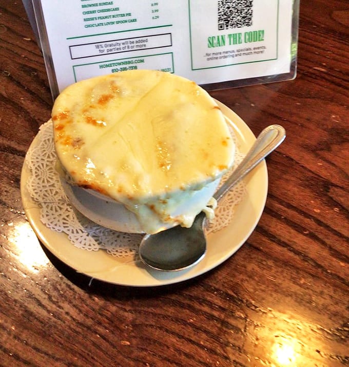 French onion soup under a golden cheese canopy&mdash;the kind of comfort that makes you forget whatever problems you walked in with.