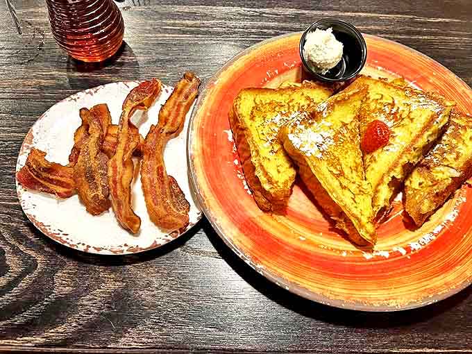 French toast that's had a proper education in decadence, served with crispy bacon that appears to have been cooked by someone who truly understands breakfast's higher purpose.