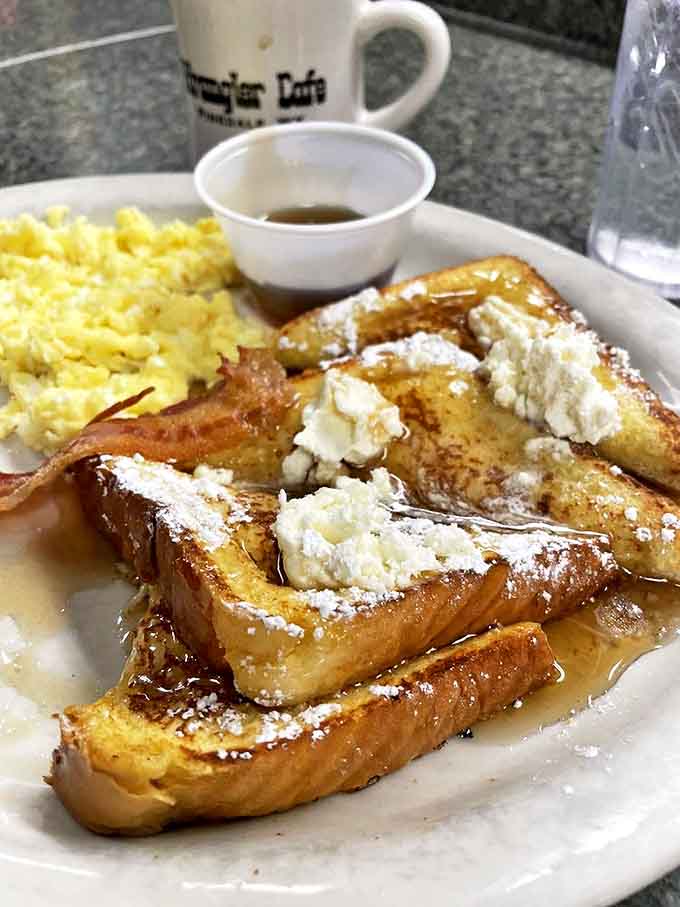 French toast that makes you understand why people write songs about breakfast. That powdered sugar dusting isn't decoration&mdash;it's the final brushstroke on a masterpiece.