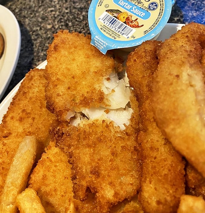 Perfectly golden fish fillets that make you wonder if the cook has some secret pact with the frying gods&mdash;crispy exterior, flaky interior, and not a drop of excess oil.