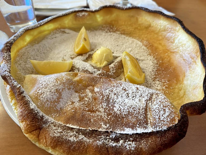 The German pancake arrives at your table like a puffy, golden cloud that somehow tastes even better than it looks.