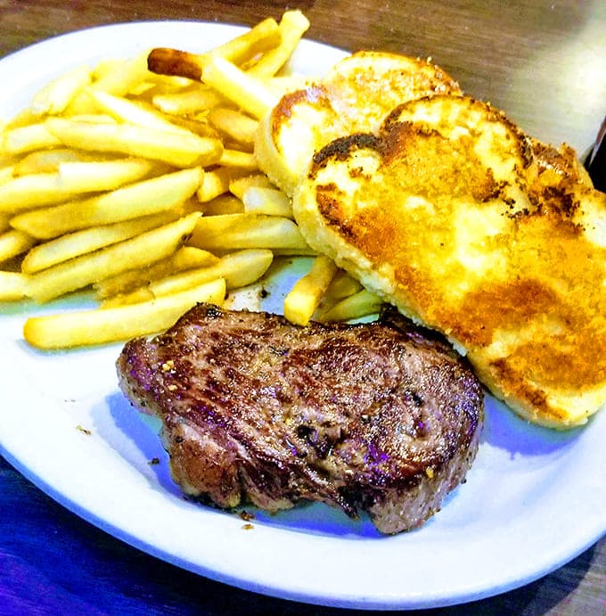 Sometimes simplicity speaks volumes. This steak, grilled cheese, and fries combo is the culinary equivalent of a perfectly tailored suit.