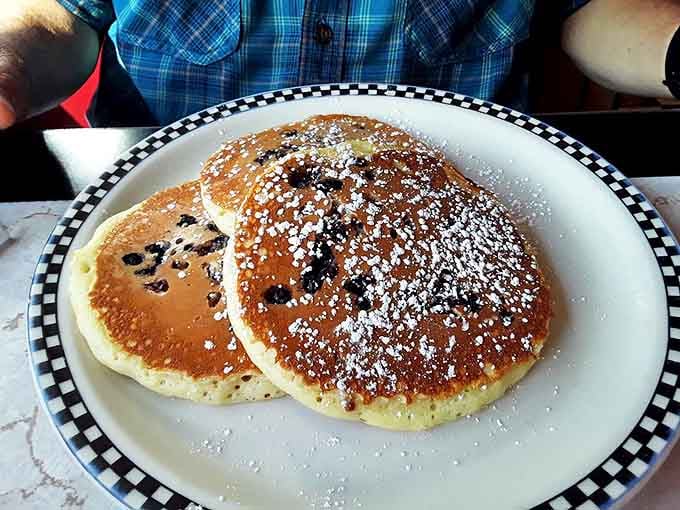 Blueberry pancakes dusted with powdered sugar&mdash;fluffy enough to use as a pillow if you weren't so busy devouring them.