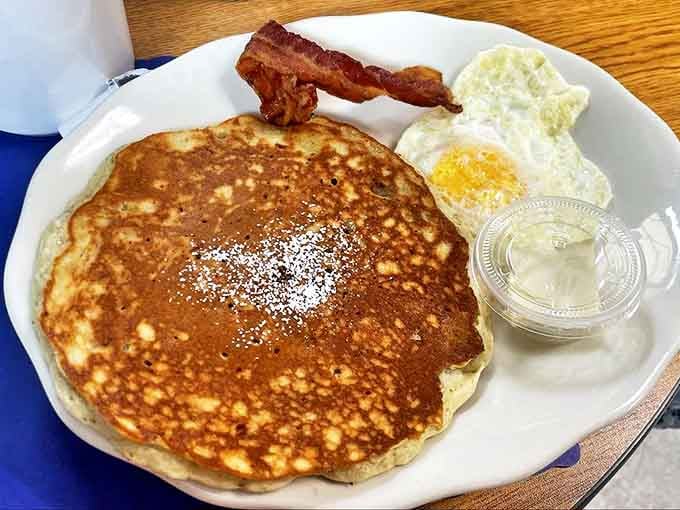 This pancake isn't just big &ndash; it's the size of your childhood dreams, golden-brown and ready to soak up maple syrup like it was born for the job.