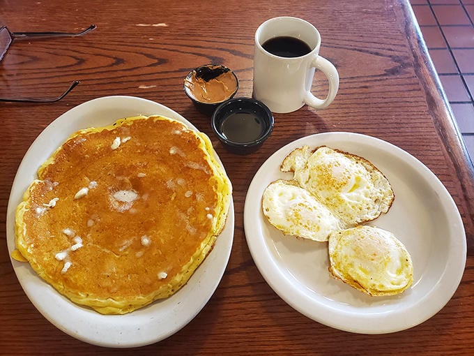 The pancake that ate La Plata! Golden, plate-sized perfection with eggs sunny-side up—breakfast architecture at its finest.