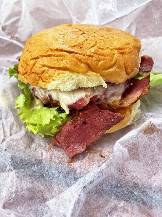 This isn't just a sandwich; it's architecture. Layers of pastrami, cheese, and fresh veggies nestled between sweet bread that changes everything you thought you knew.