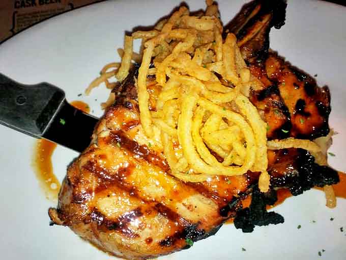 A pork chop that's dressed to impress with crispy onion strings &ndash; like putting a tuxedo on an already handsome cut of meat.