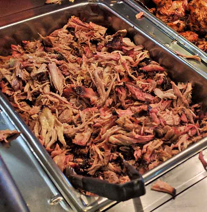 Pulled pork so tender it practically surrenders at the sight of your fork – with that telltale pink smoke ring that barbecue aficionados dream about.