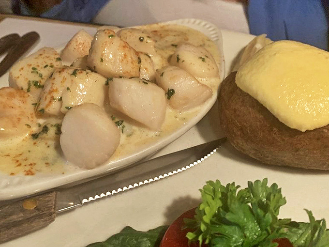 These scallops aren't just cooked&mdash;they're respected, bathed in butter and herbs with a baked potato standing by for backup.