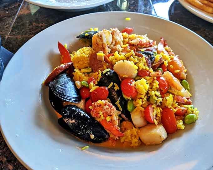 Seafood paella that's having a party on your plate, with each colorful ingredient vying for your attention.