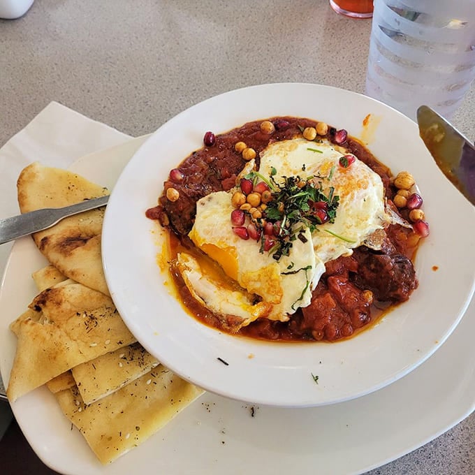 Shakshuka that transports you straight to the Mediterranean, with eggs that swan-dive into a spiced tomato bath topped with pomegranate jewels.