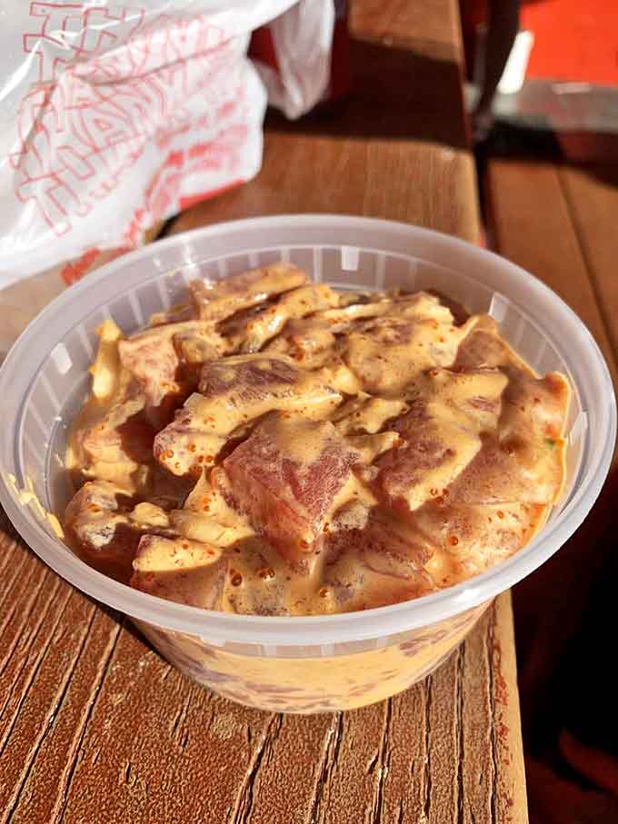 Glistening chunks of spicy tuna poke—each bite delivers an ocean-fresh punch followed by a gentle heat that builds like a Hawaiian sunrise.