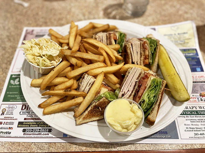 The club sandwich: architectural marvel, flavor powerhouse, and the reason napkins were invented. A true diner classic elevated to art.