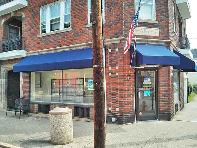 This brick corner building with blue awnings represents small-town America at its finest. Where everybody might not know your name yet, but they're willing to learn.