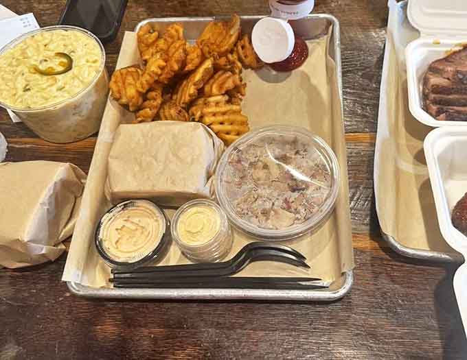 A tray of possibilities—waffle fries, sauces, and wrapped treasures waiting to be discovered. Like Christmas morning for your taste buds.