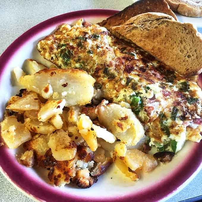 This western omelet has more color than a sunset and twice the flavor. Those home fries look like they've earned their PhD in crispiness.