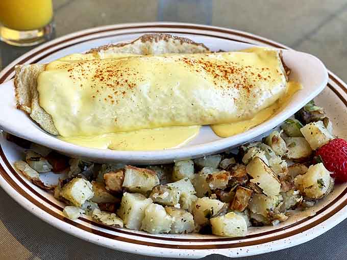 Sunshine-yellow hollandaise cascades over this crepe creation like a delicious waterfall, with crispy potatoes standing by for the encore.