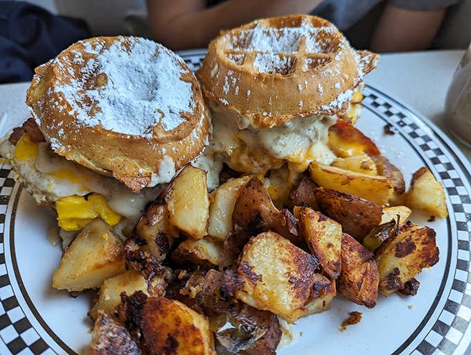 The Belgian waffle sandwich defies gravity and good sense in the best possible way. Powdered sugar dusted waffles embracing eggs and cheese&mdash;morning bliss on a plate.