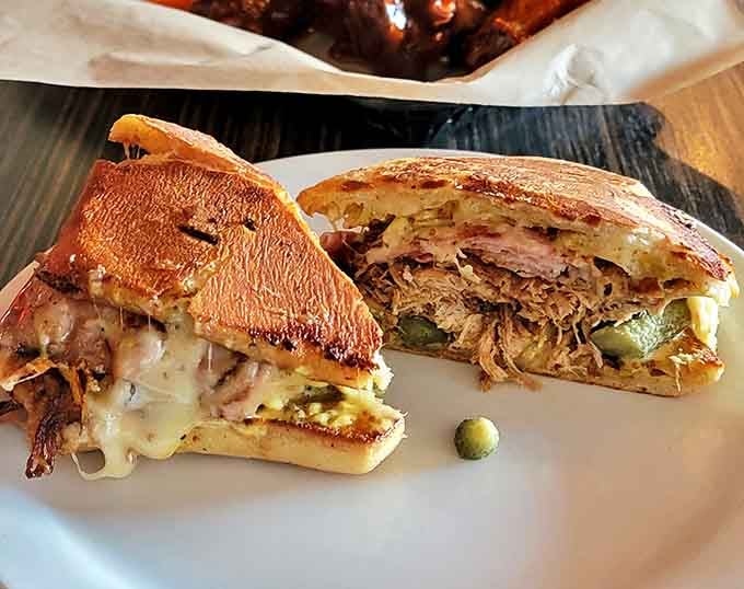 The chicken sandwich, sliced to reveal its secrets, sits proudly on a plate like it knows exactly how good it is.