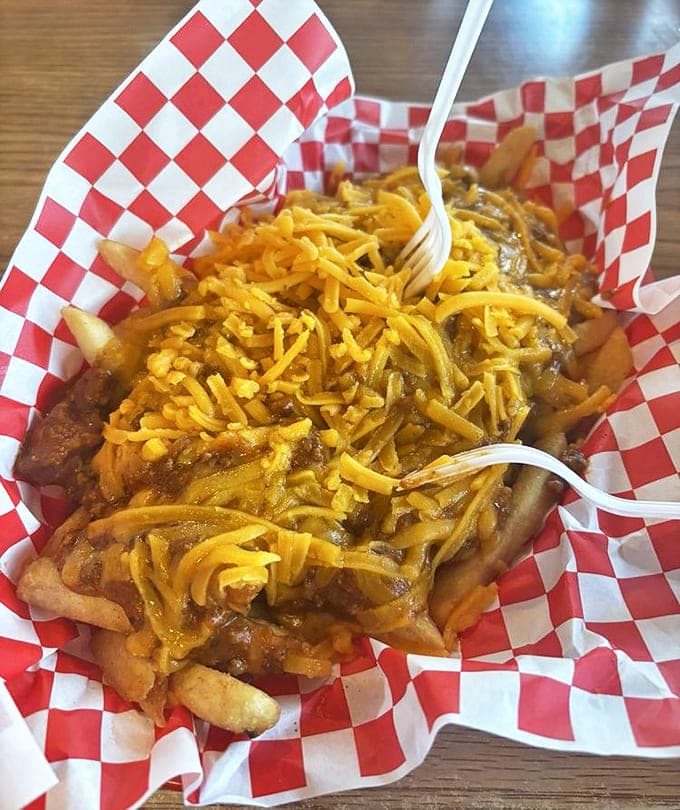 Chili cheese fries that demand both a fork and your full attention &ndash; a beautiful mess of crispy potatoes, savory chili, and melted cheese.