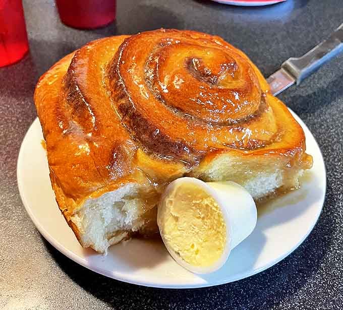 This cinnamon roll isn't just a pastry, it's an event—a spiral of morning joy with butter melting into every crevice.