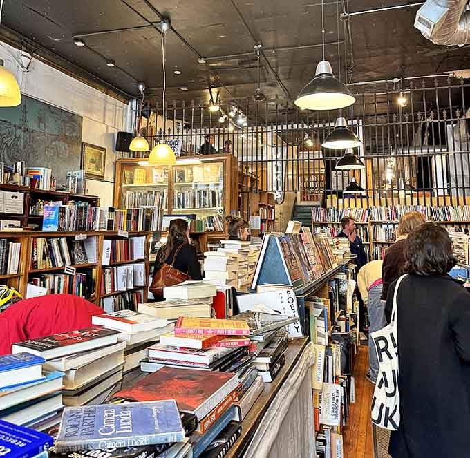 The checkout counter doubles as a social hub where strangers become friends over shared literary obsessions.