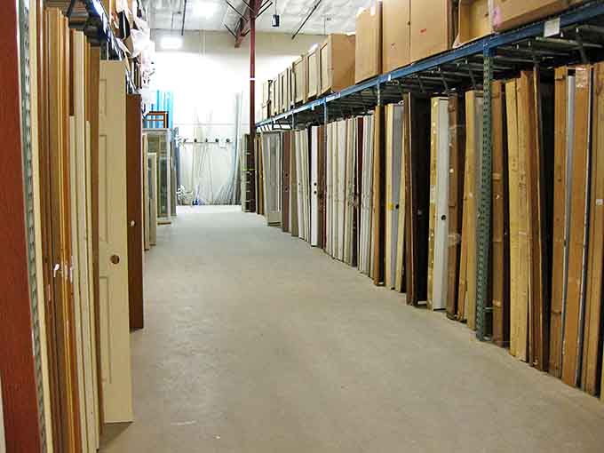 The door corridor stretches like an architectural version of infinity mirrors—possibilities as far as the eye can see.