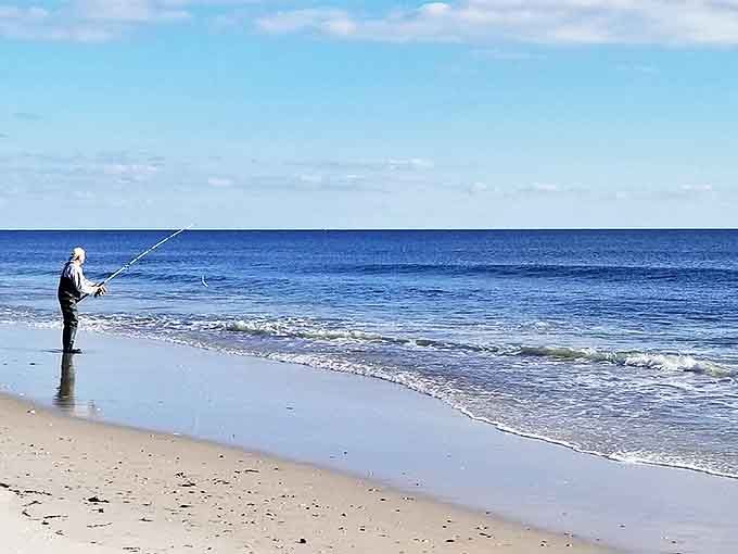 Patience personified: A solitary angler casts hopes and dreams into the Atlantic, proving fishing isn't just about catching&mdash;it's about the magnificent waiting.