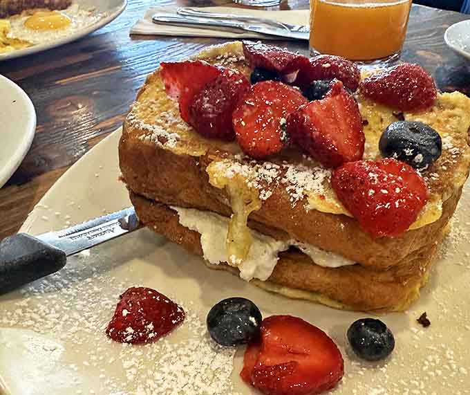The stuffed French toast that launched a thousand road trips – berry-topped, cream-filled, and worth setting your alarm for.