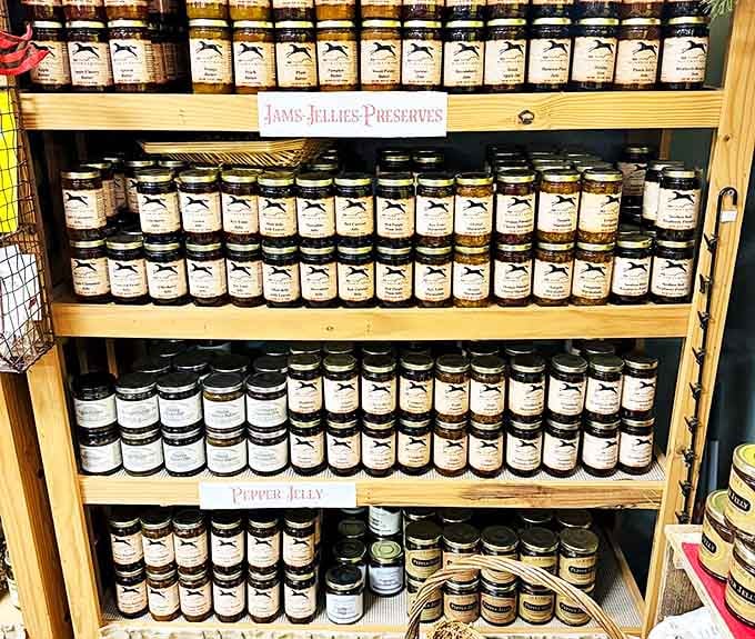A pantry's worth of homestyle preserves, arranged with the precision of a museum exhibit. Grandma's recipes, professionally jarred.
