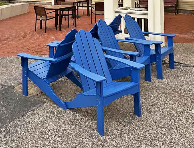 Adirondack chairs in brilliant blue&mdash;where shopping marathoners rest their legs while planning which store deserves their next financial contribution.