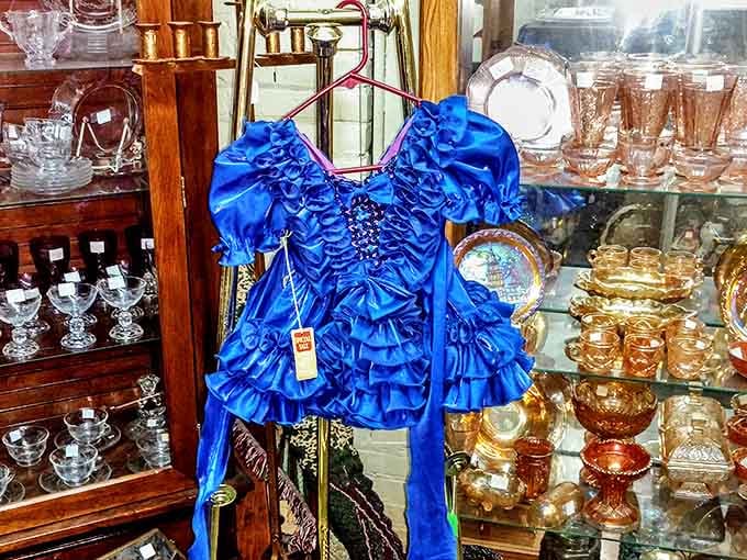 That blue dress isn't just ruffled&mdash;it's practically having a conversation with the amber Depression glass behind it.
