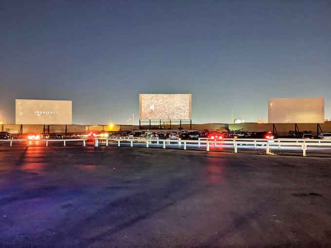 As dusk settles, the drive-in's screens stand ready for their nightly performance. Vegas's most reliable show doesn't involve a single playing card.
