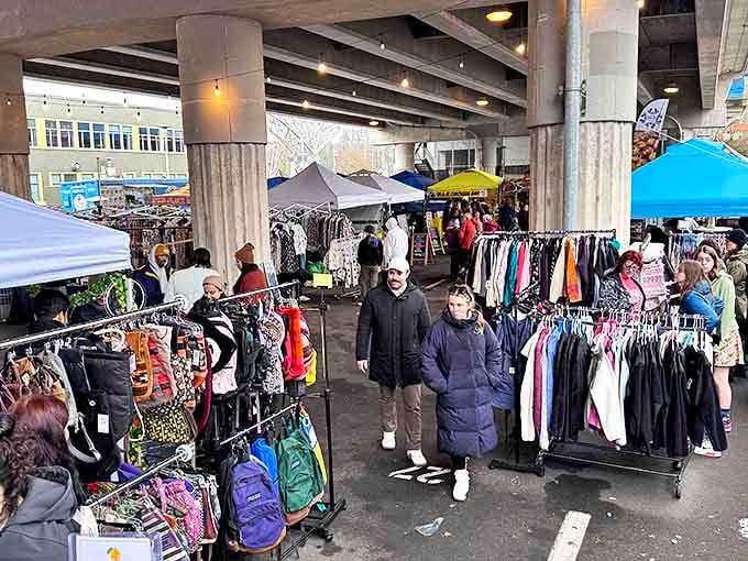 Under the Aurora Bridge, shoppers navigate the clothing forest where yesterday's fashions become tomorrow's statement pieces.