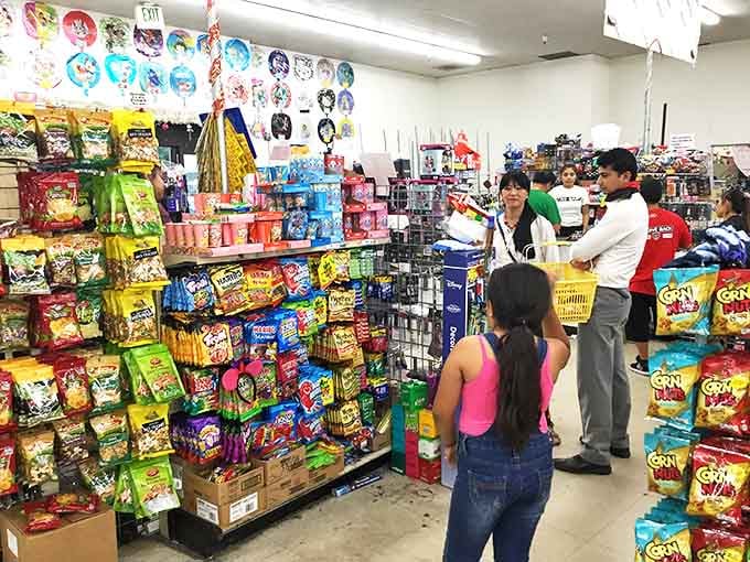Shoppers navigate the candy cosmos with the focused determination of kids in a toy store on Christmas Eve.