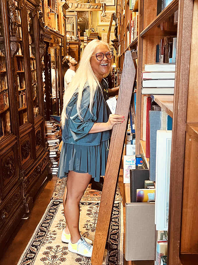 A warm glow casts over towering shelves that would make Belle from Beauty and the Beast consider relocating to Fort Lauderdale.