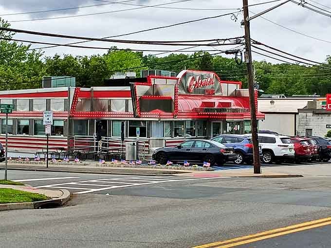 The Colonial Diner's gleaming red and silver exterior shines like a beacon for the breakfast-obsessed. Pancake paradise awaits!