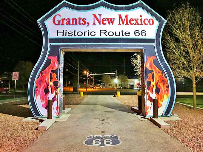 Grants' Route 66 gateway glows with neon nostalgia at twilight. This flaming portal invites road-trippers into a town where retirement dollars burn brighter.